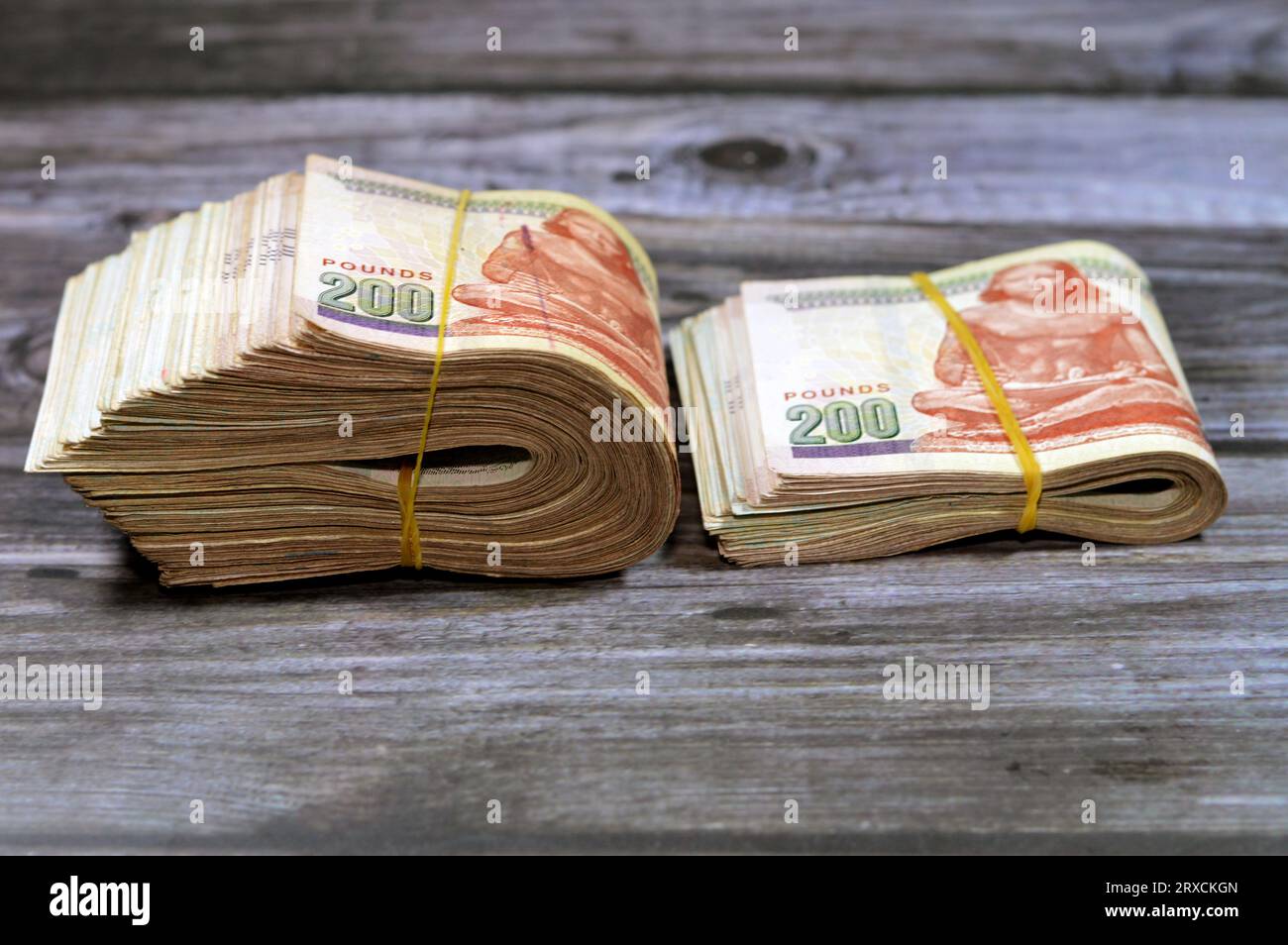 Folded Egyptian money isolated on wooden background, 200 LE two hundred ...