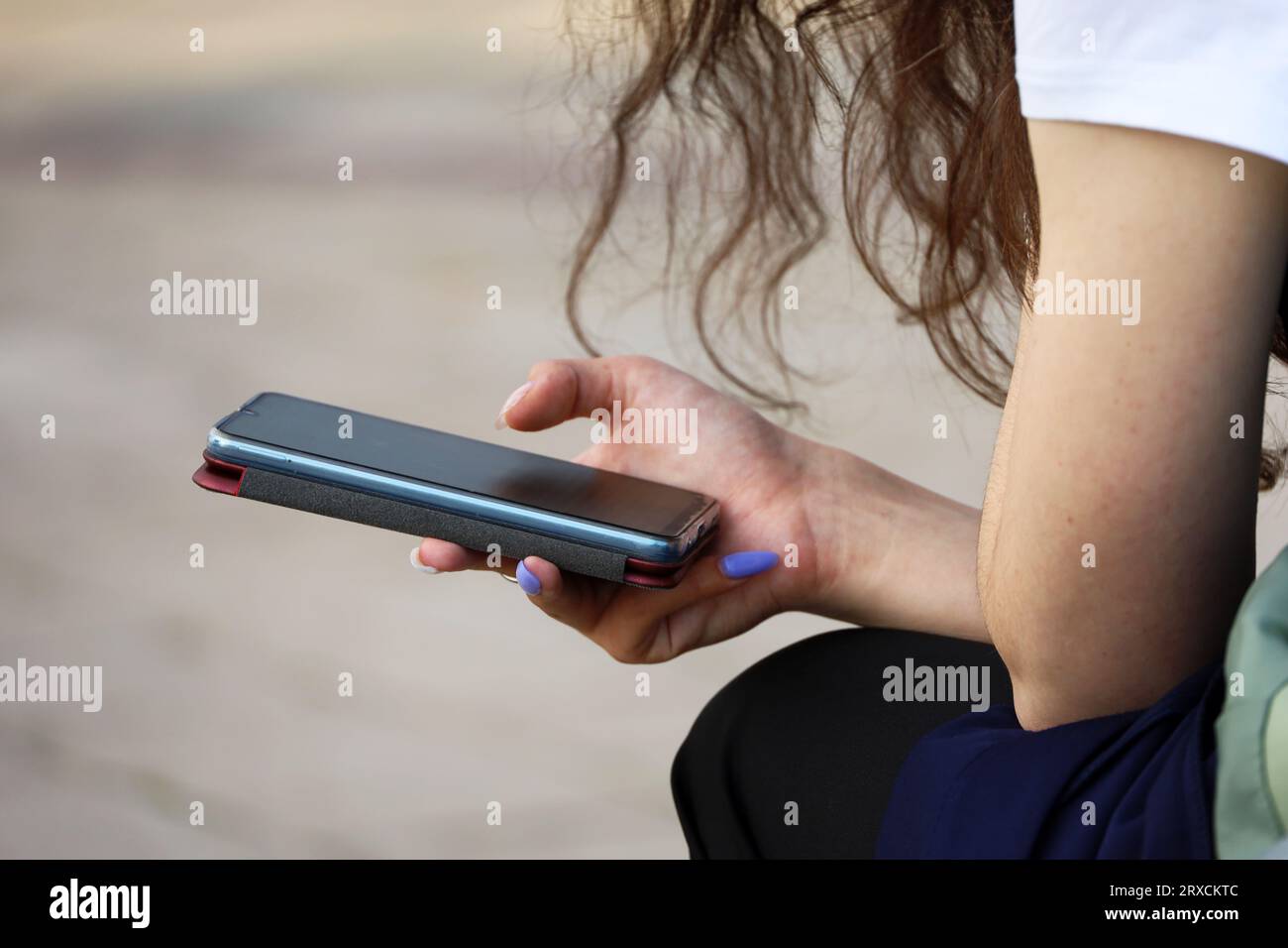 Smartphone in female hands close up. Girl using mobile phone while ...