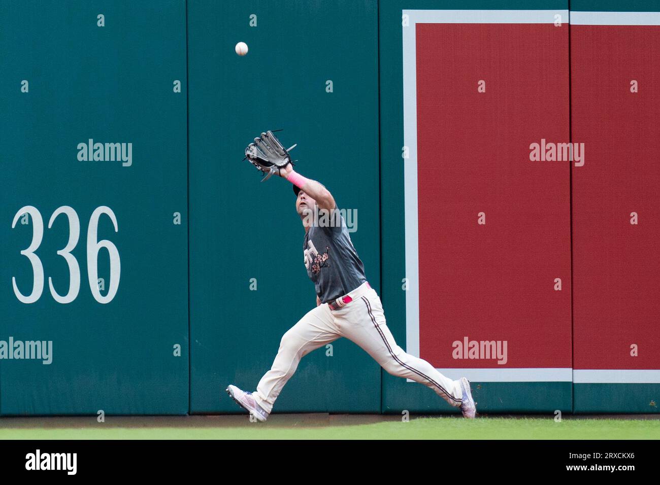 Washington Nationals left fielder Jake Alu catches a fly ball hit in by ...
