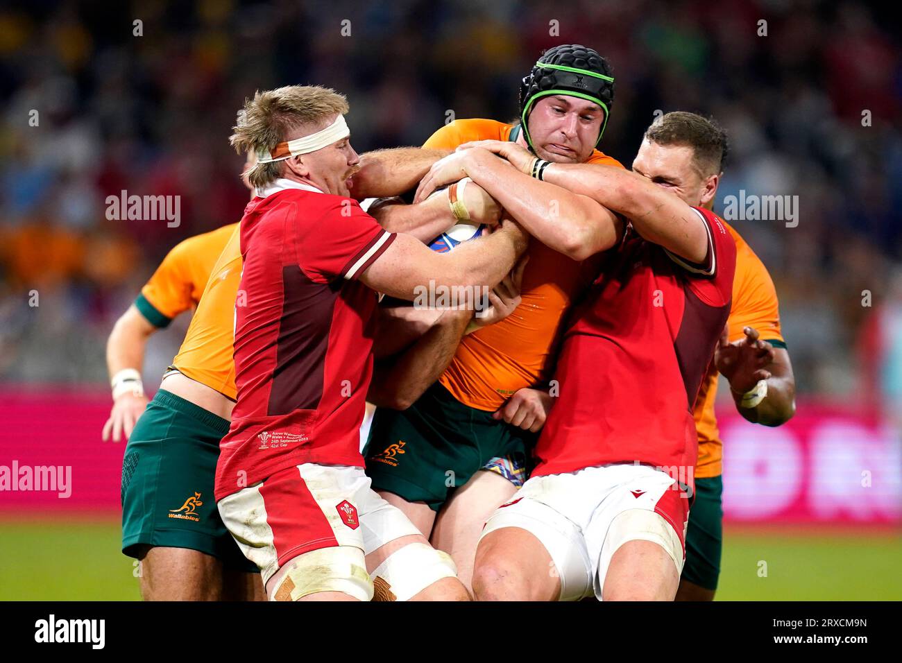 Australia's Nick Frost (centre) tackled by Wales' Will Rowlands (left ...