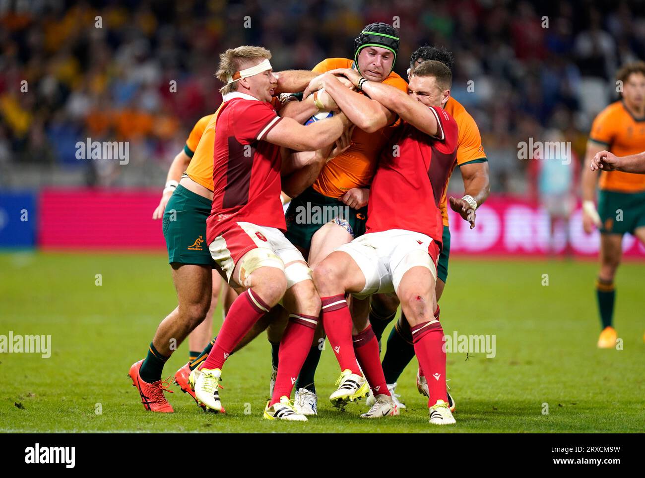Australia's Nick Frost (centre) tackled by Wales' Will Rowlands (left ...