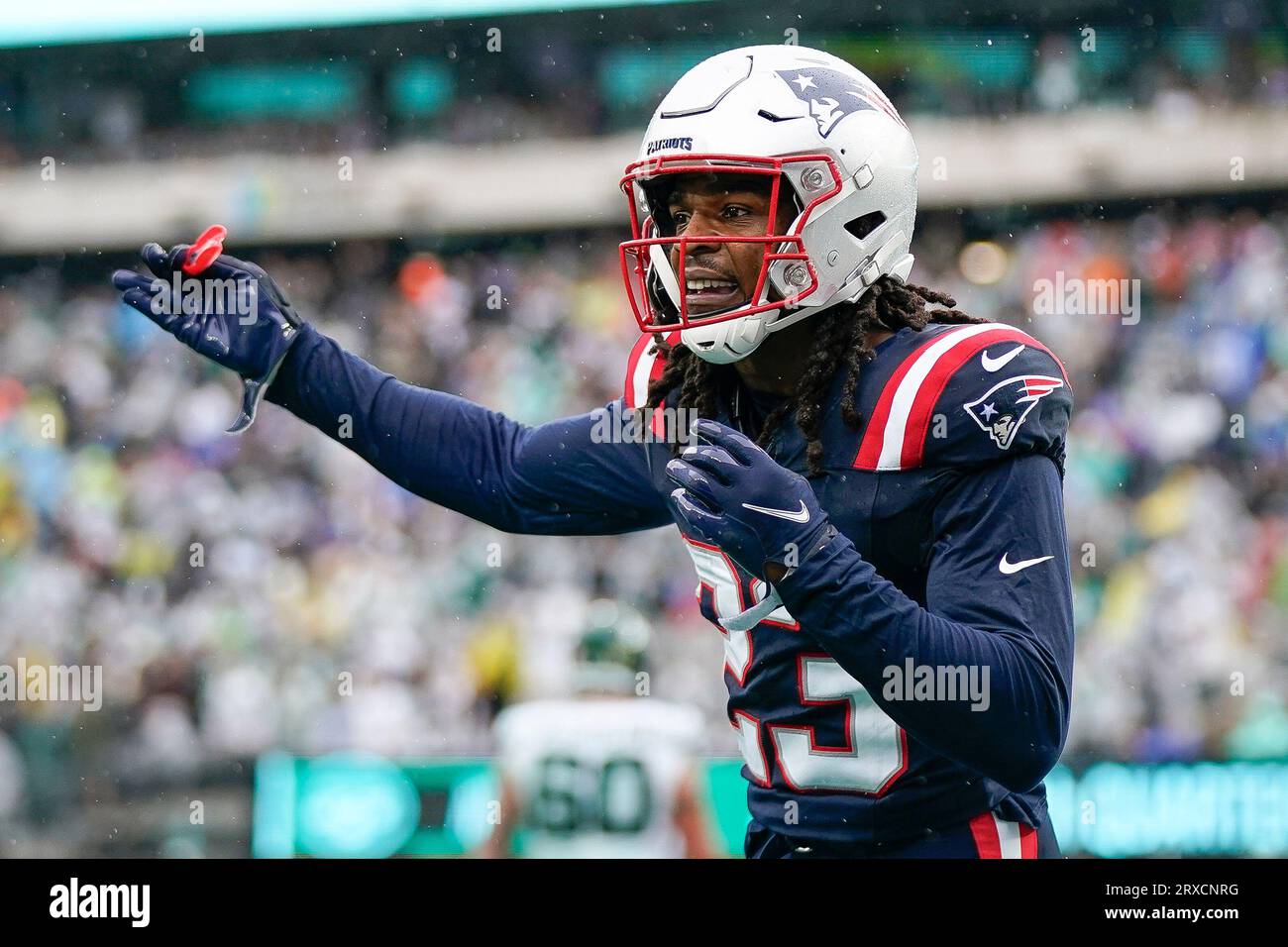 New England Patriots safety Kyle Dugger (23) agrees with an official's ...