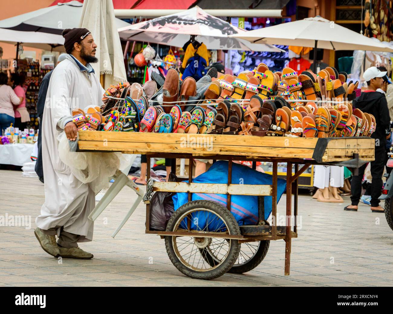 Marrakech, Morocco, April 8th, 2023. A Moroccan male vendor pushing a ...