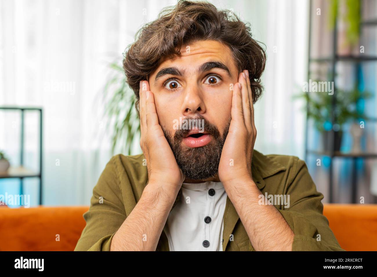 Oh my God Wow. Excited amazed young man surprised looking at camera ...