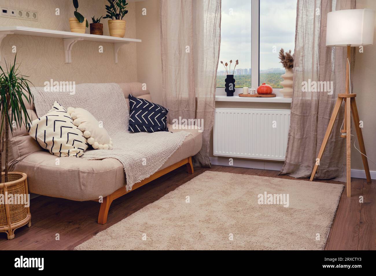 Interior of a living room with a sofa and a window Stock Photo - Alamy