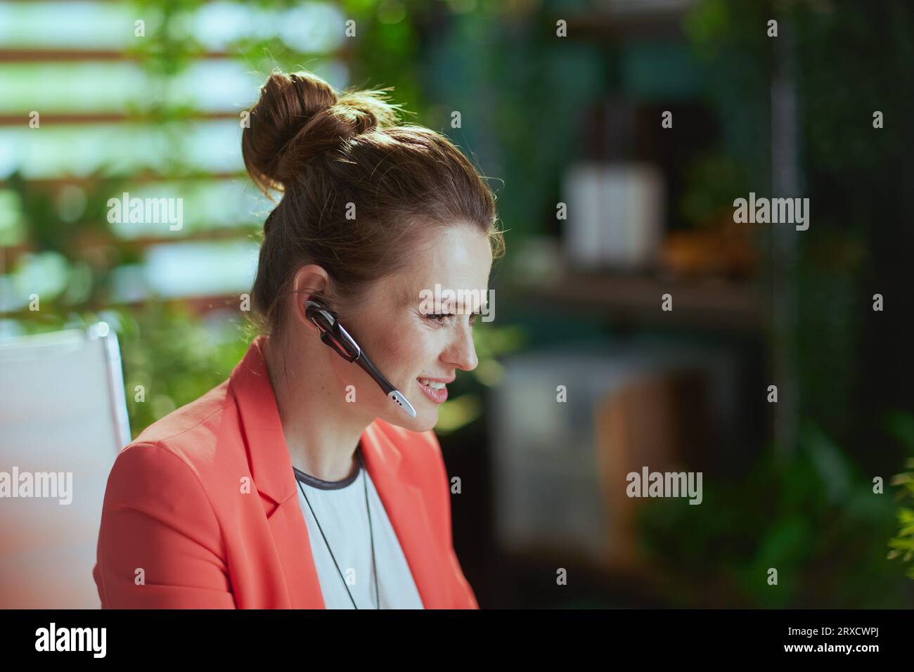 Sustainable workplace. happy modern business woman in modern green ...