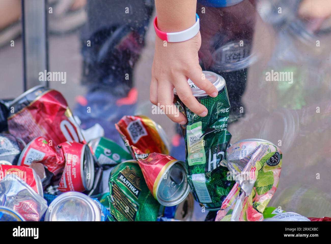 Unknown people collect and recycle cans. Banks are produced and ...