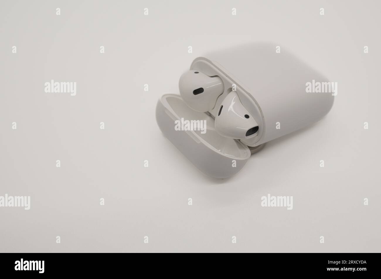 wireless earbuds in a case on a white background Stock Photo - Alamy