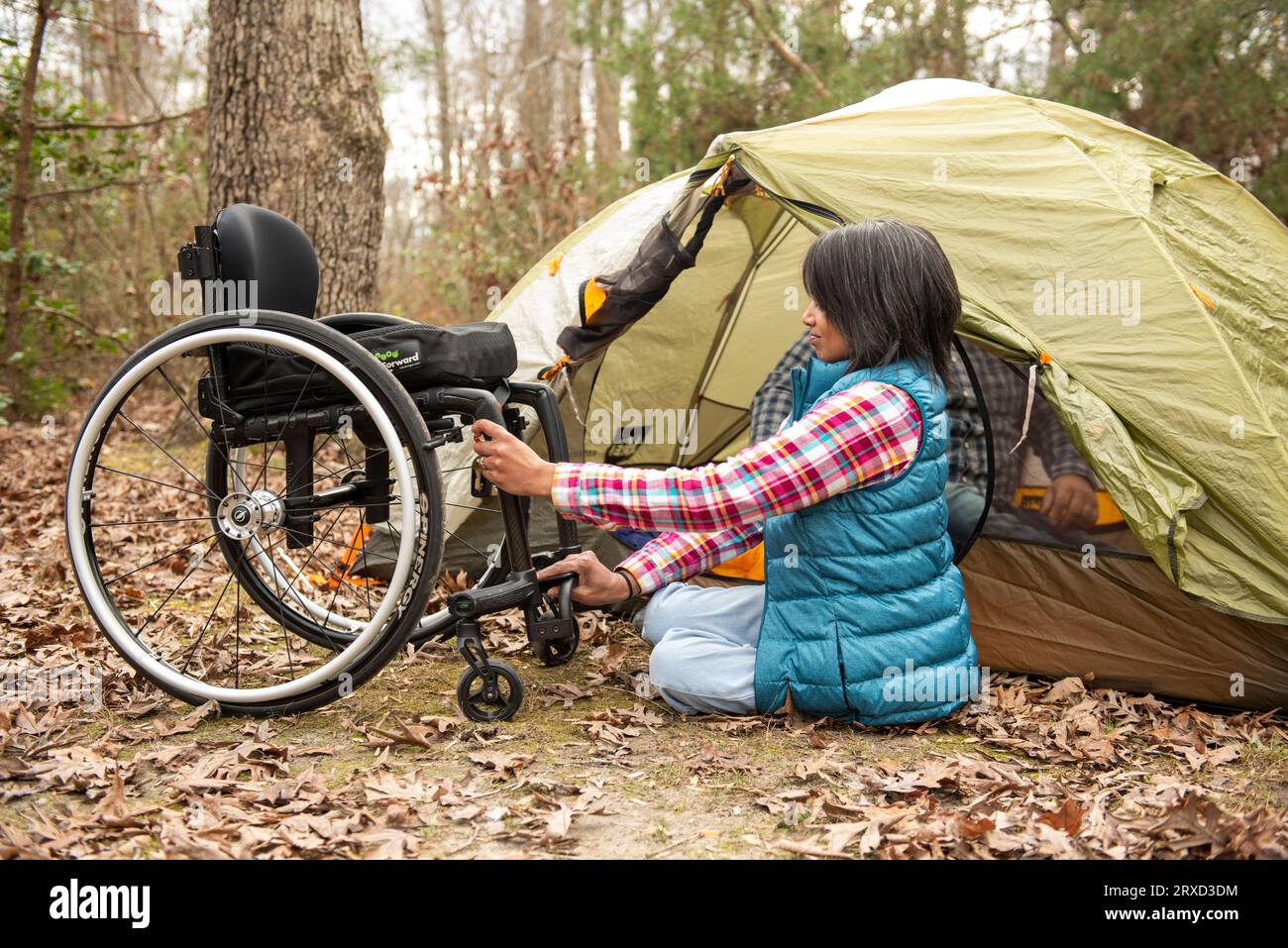 A disabled woman enjoys nature at a campsite. Being in a wheelchair ...