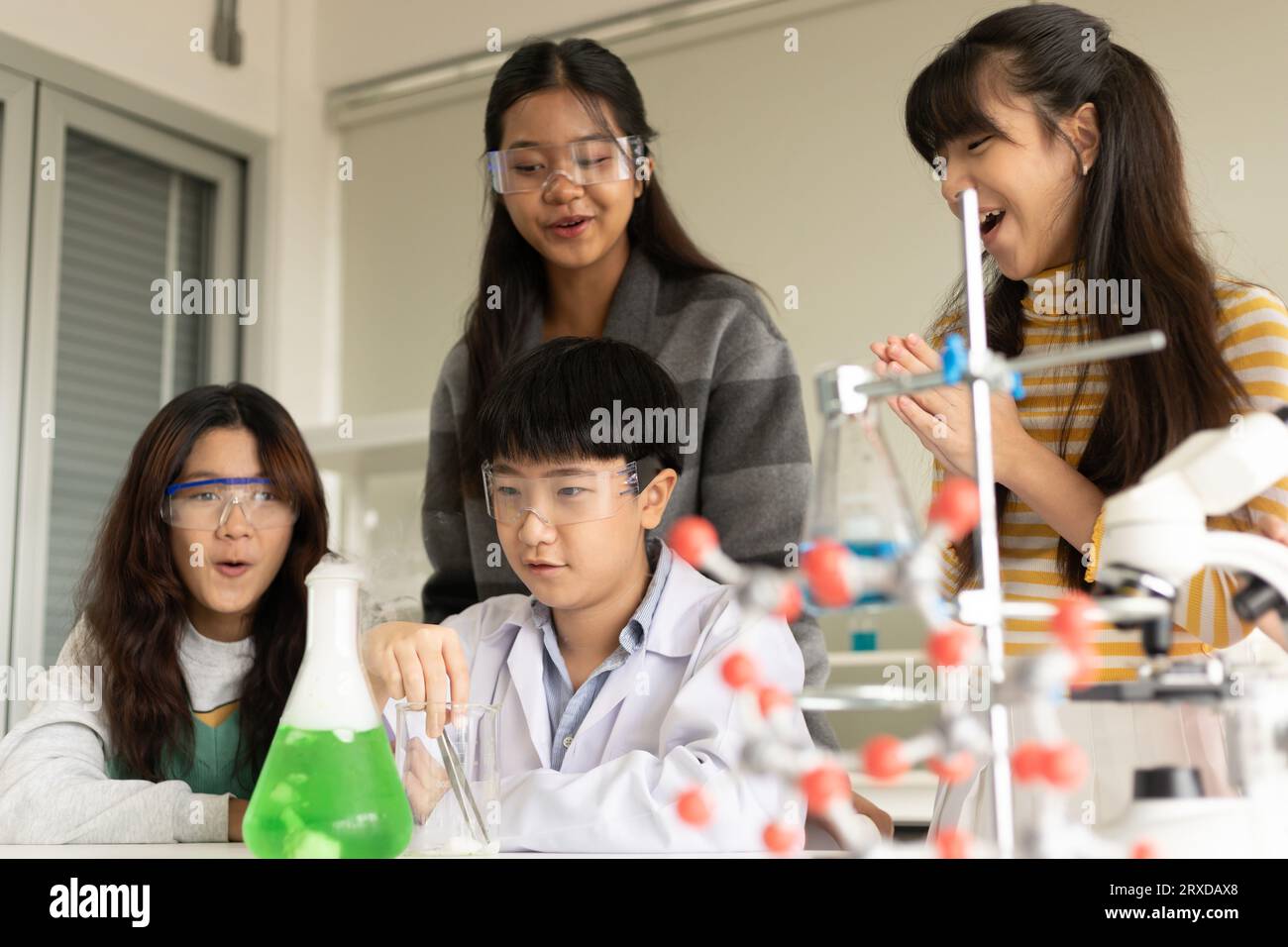STEM education concept. Asian children in laboratory research an ...