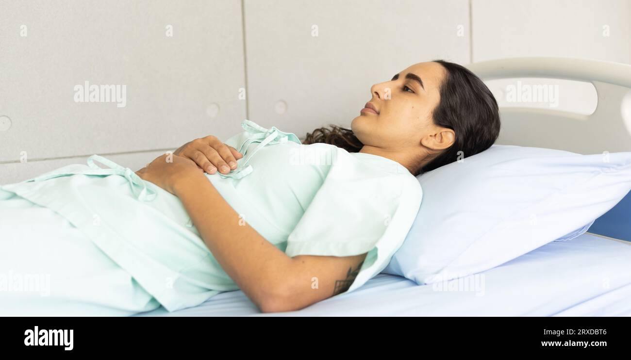 Hispanic female patient in the hospital ward. Waiting for a doctor to ...