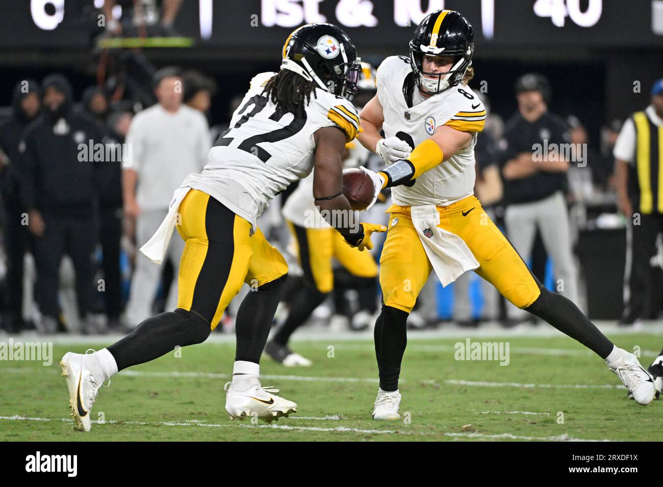 Pittsburgh Steelers quarterback Kenny Pickett, right, hands off to ...