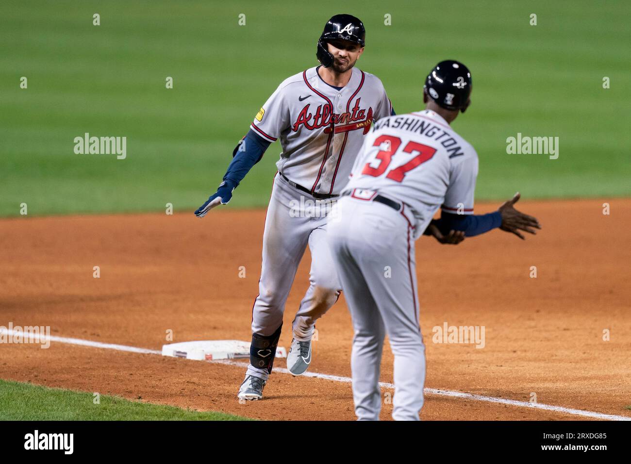 Atlanta Braves' Forrest Wall, left, celebrates with third base coach ...