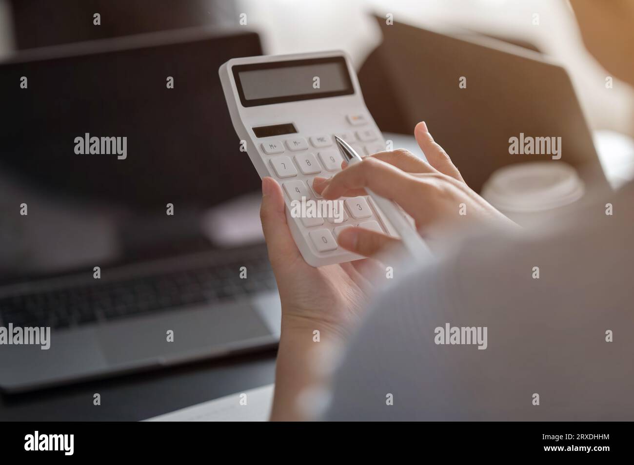 Close-up rear view image of a businesswoman or female accountant using ...