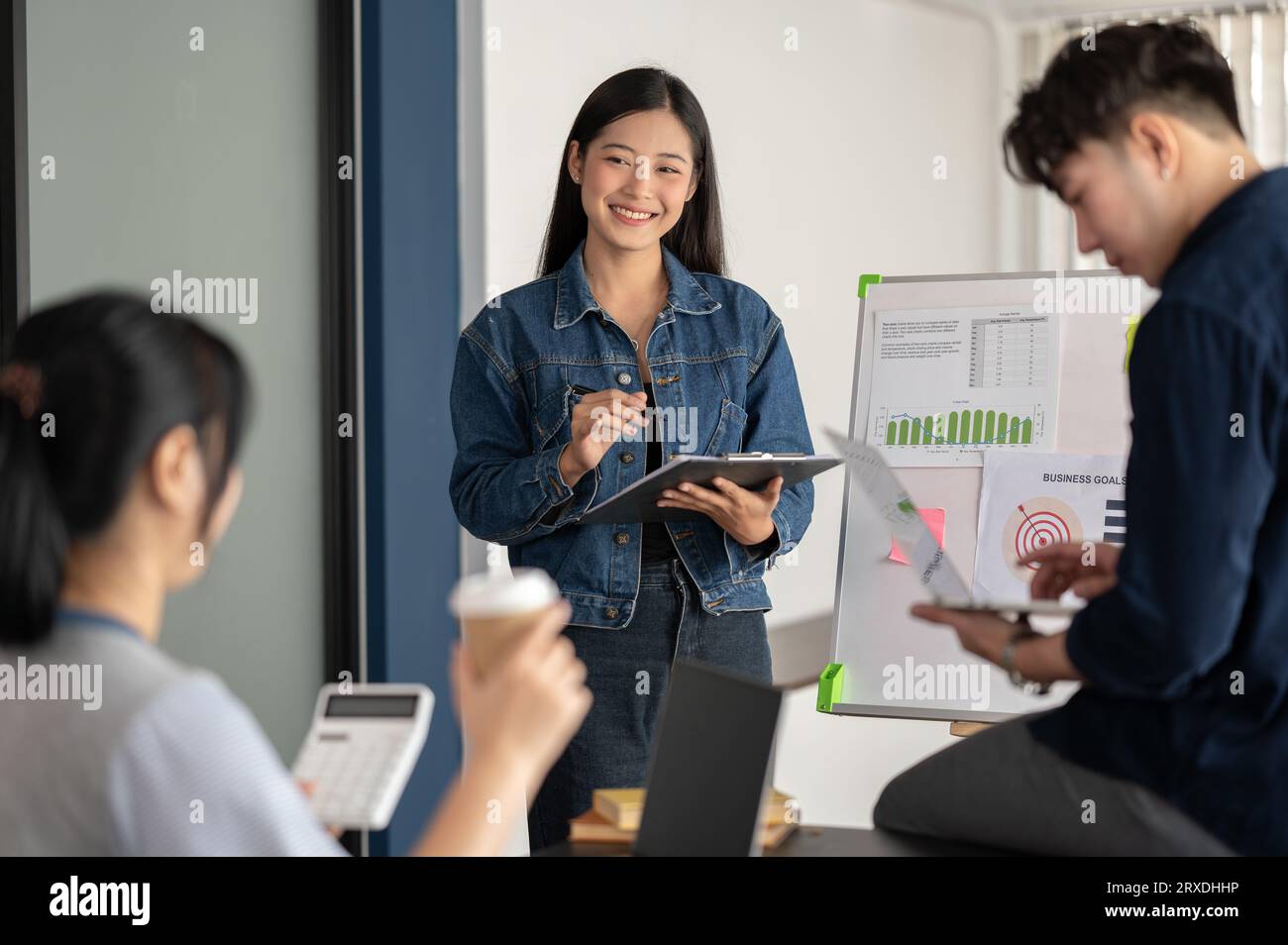 A happy and beautiful young Asian businesswoman is working as a team ...