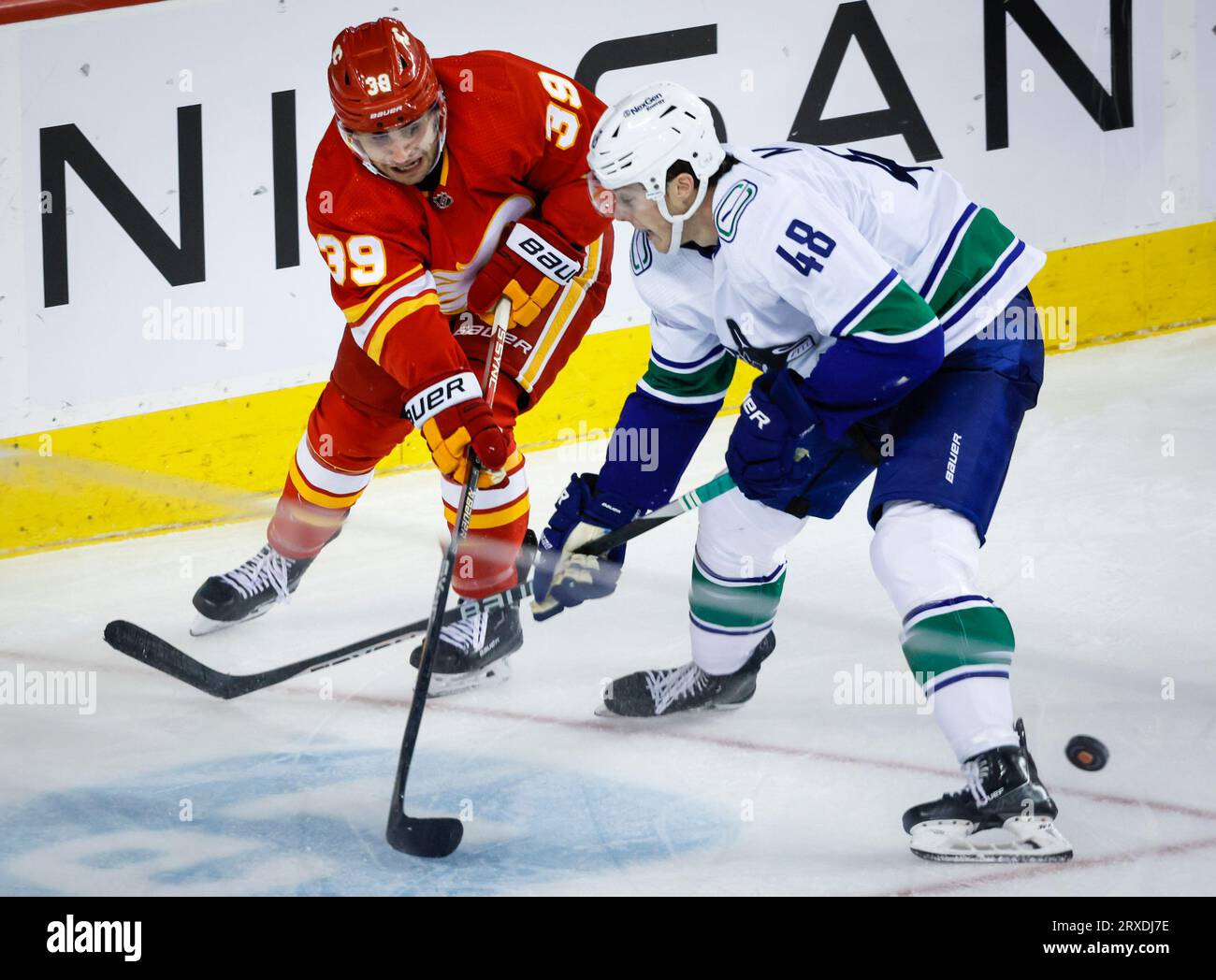 Vancouver Canucks' Cole McWard, right, checks Calgary Flames forward ...