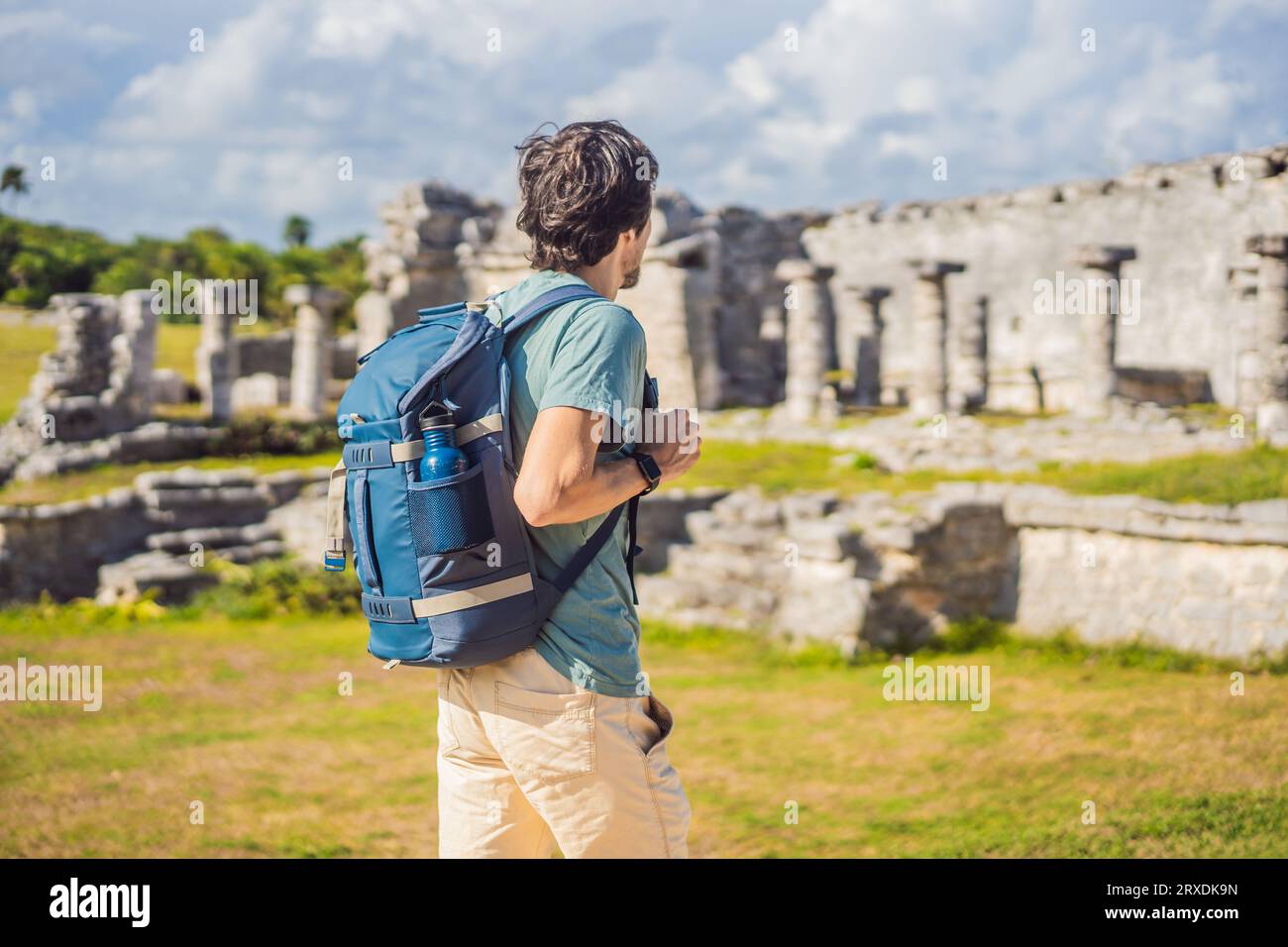 Male tourist enjoying the view Pre-Columbian Mayan walled city of Tulum ...
