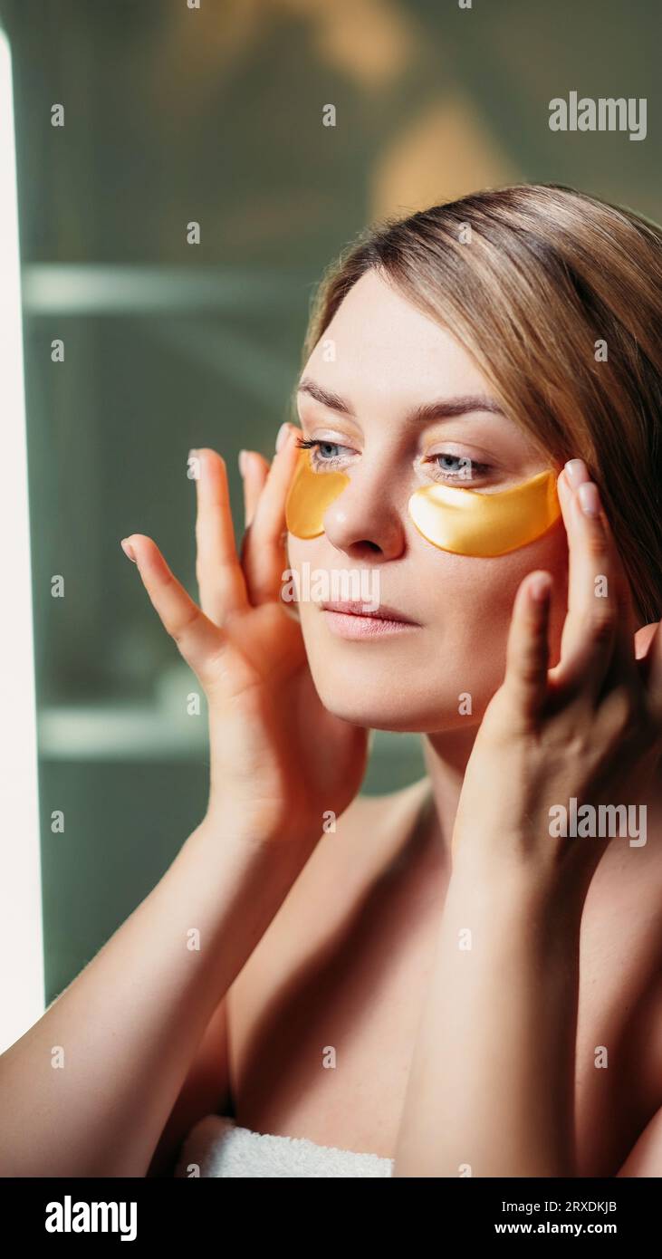 Eye patches facial care woman applying pads face Stock Photo - Alamy