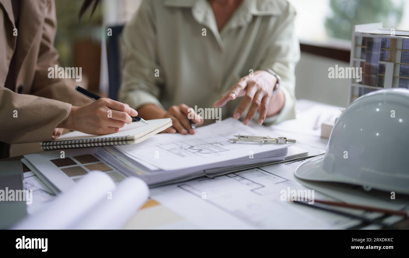 Two female architects discuss about interior design building project on ...