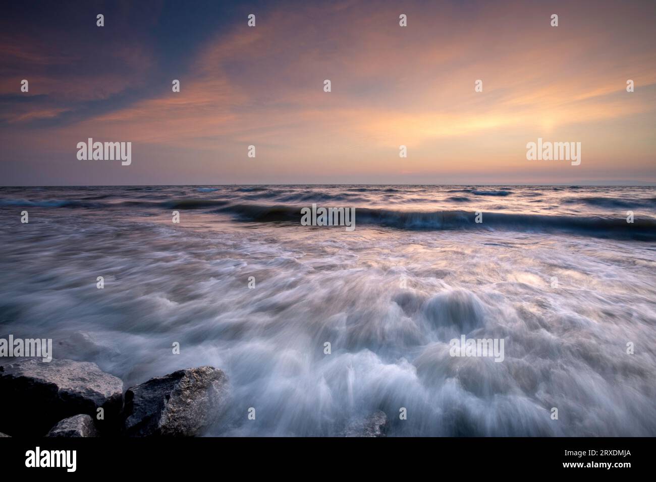 Colorful Lake Huron sunrise landscape with waves crashing on the rocks ...