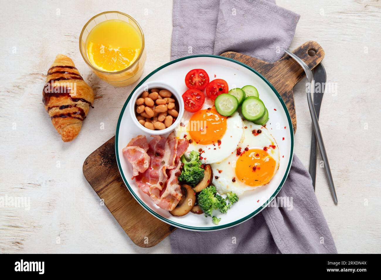 Traditional Englis breakfast plate with bacon strips, sunny side up ...