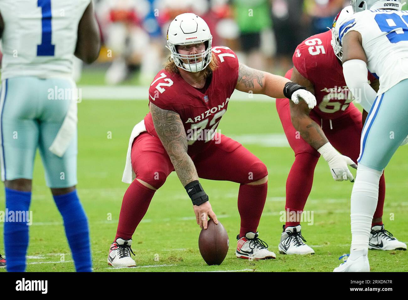 Arizona Cardinals guard Hjalte Froholdt gives signals to other linemen ...