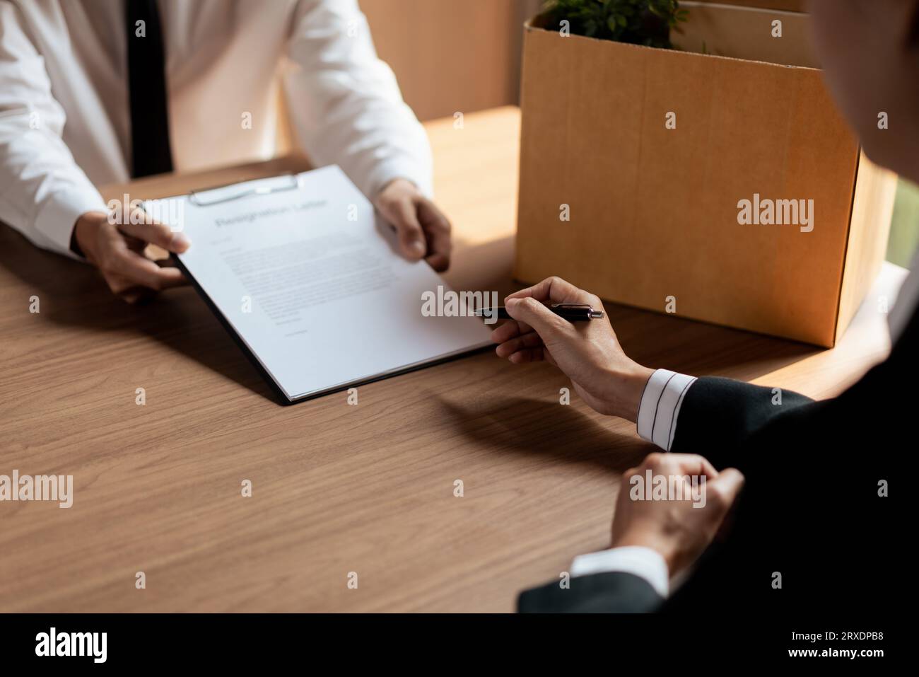 Executive signing on resignation letter for male employee when quitting ...