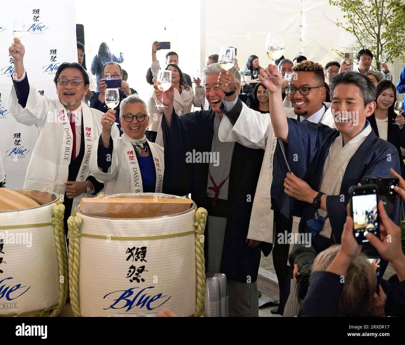 Hiroshi Sakurai (C), CEO of Asahi Shuzo, a Japanese sake brewer company ...