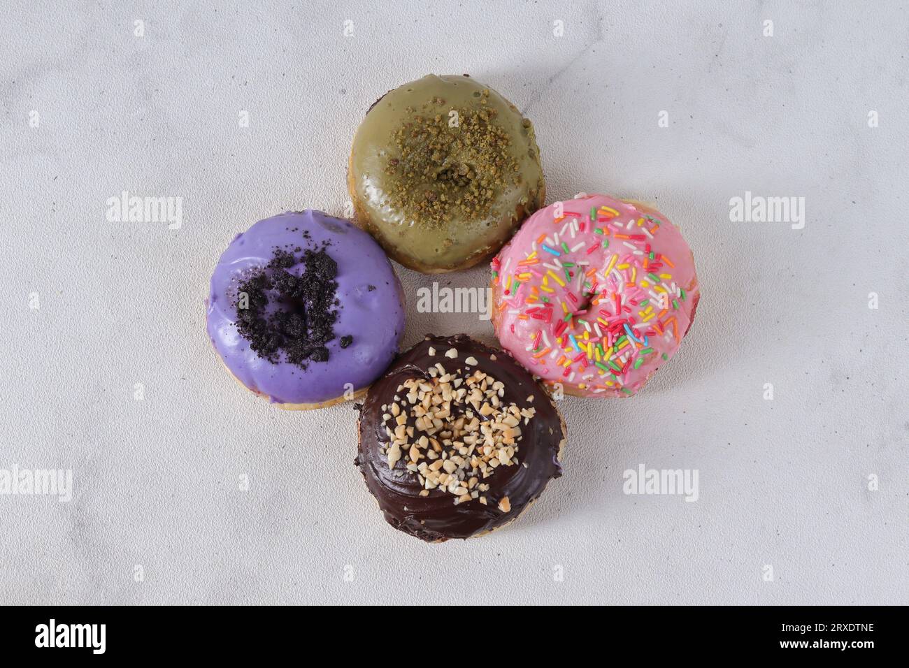 Flat lay top view of delicious sweet donuts with different flavors on a ...