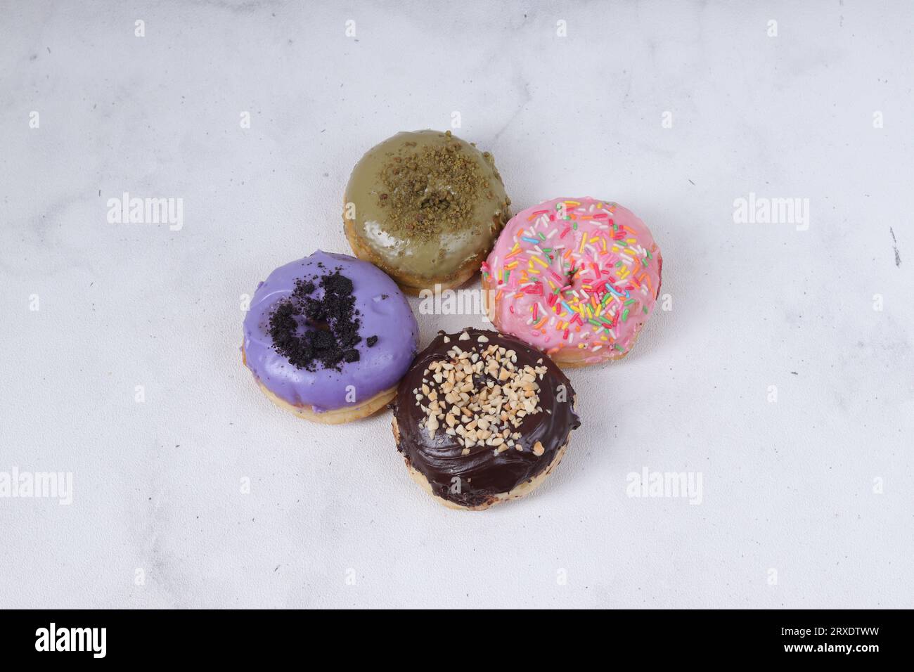 Flat lay top view of delicious sweet donuts with different flavors on a ...