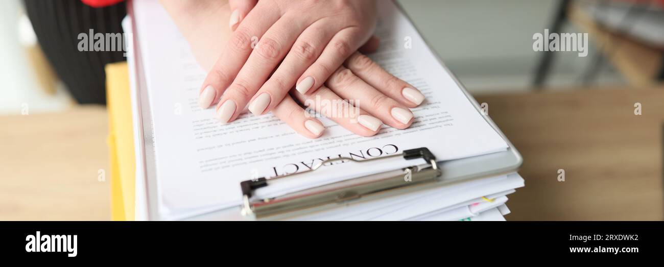 Female manager puts her hands on stack of office document, notebooks ...