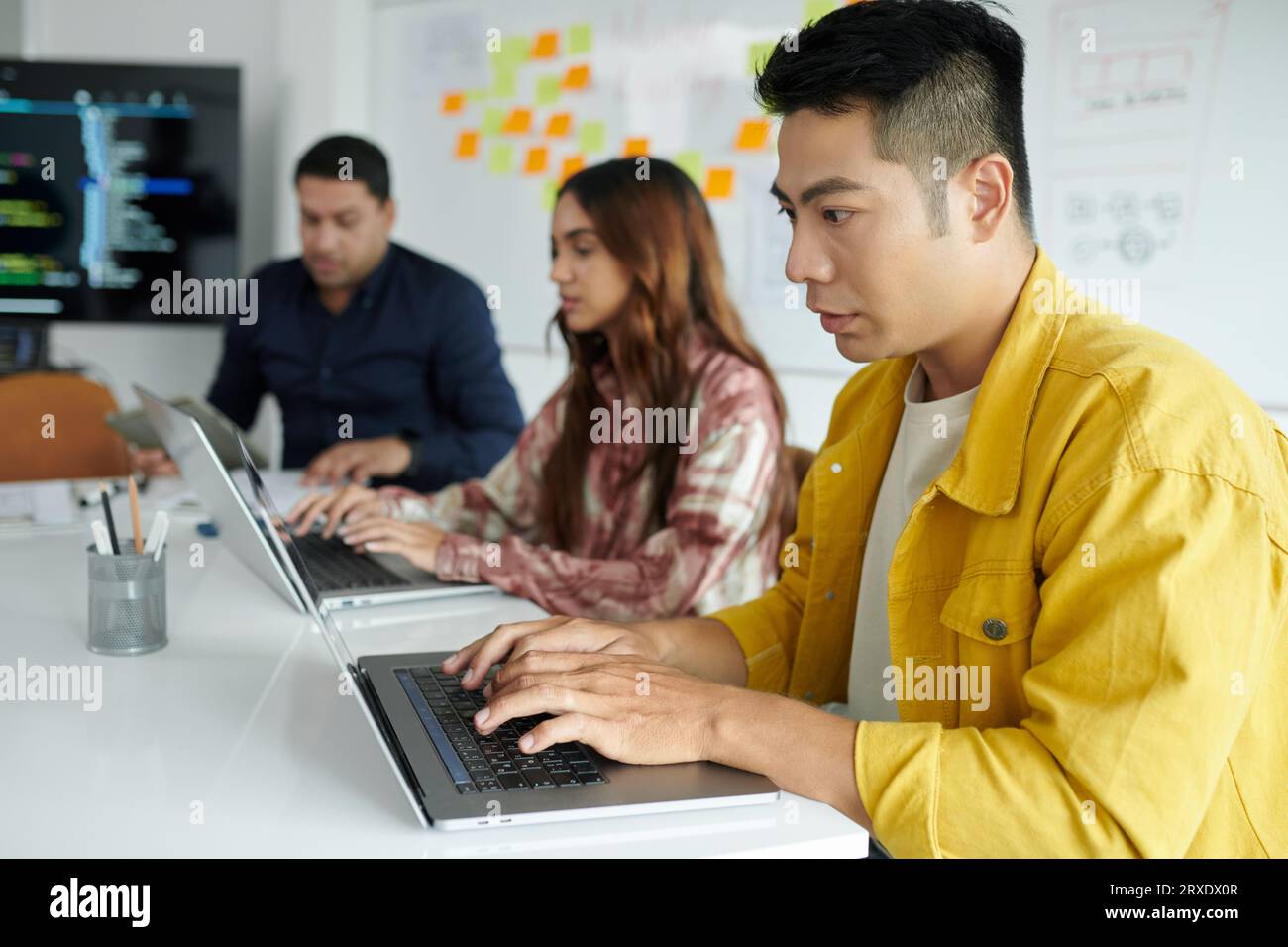 Panicking devops engineer fixing bugs in programming code Stock Photo - Alamy