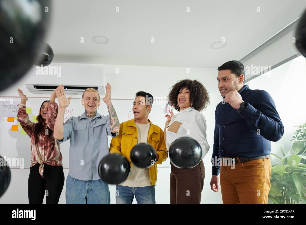 Team of developers celebrating successful startup launch Stock Photo ...