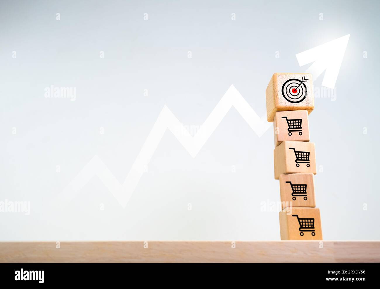 Big target icon on top of wooden cube block stack with shopping cart ...