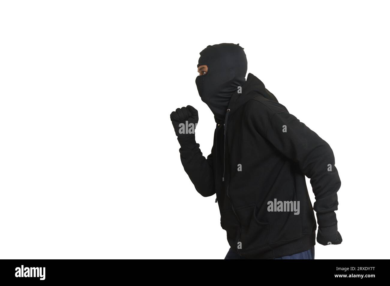 Side view portrait of a masked thief wearing black hoodie sneaking ...
