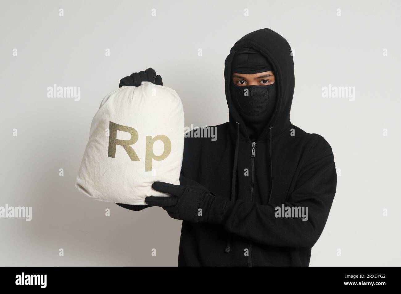 Mysterious robber thief man wearing black hoodie and mask carrying a ...