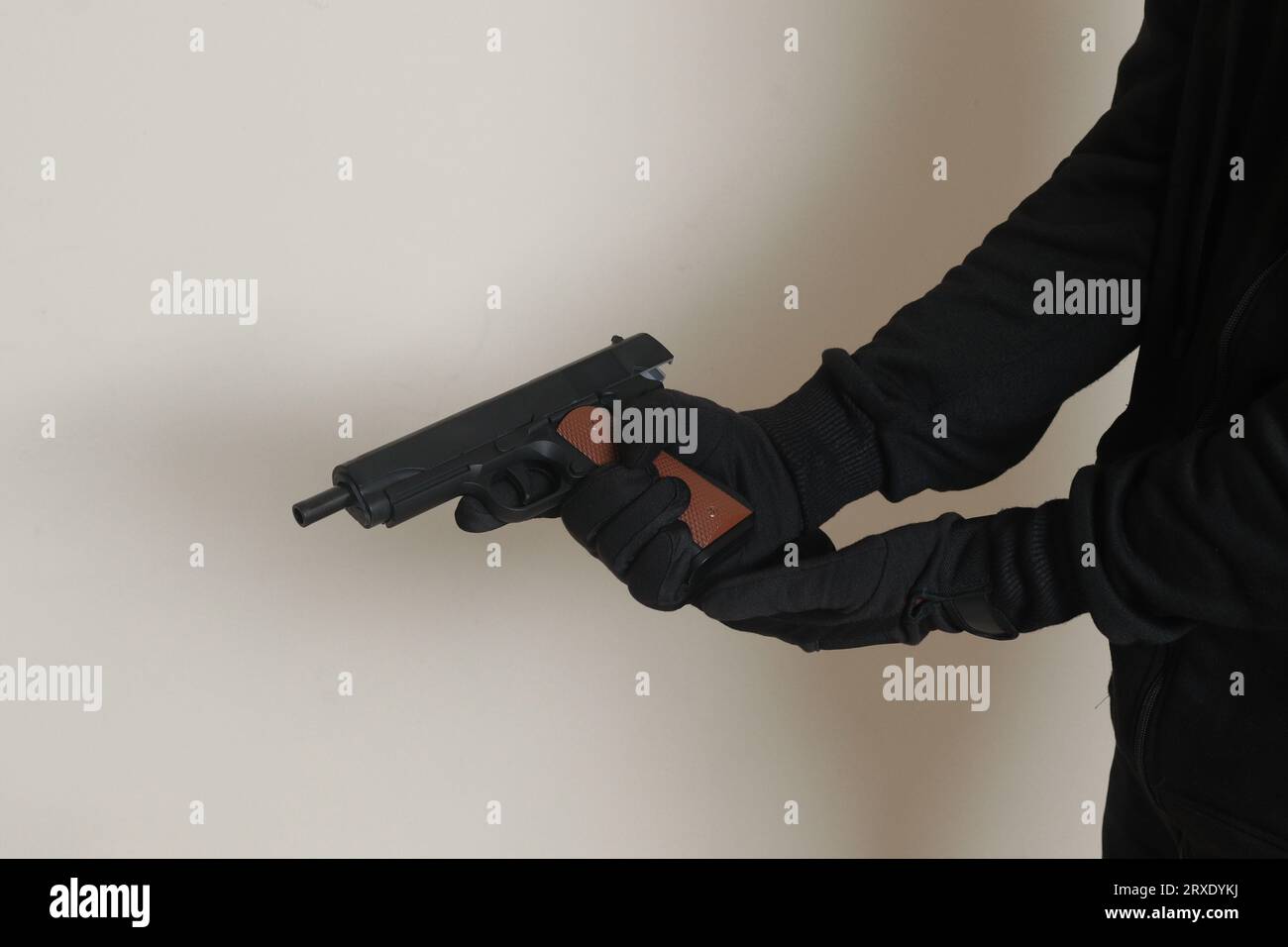 Close up of male hand reloading his pistol after shooting. Isolated ...