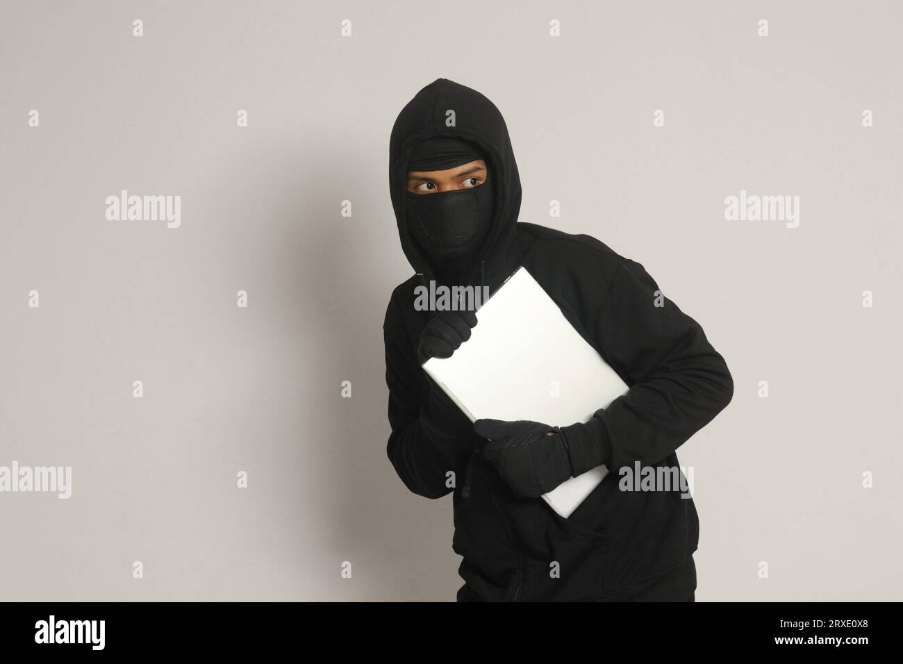 Mysterious robber thief man wearing black hoodie and mask stealing ...