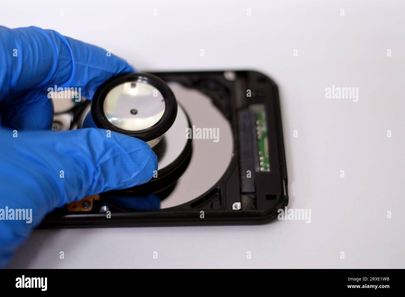 A medical stethoscope on HDD platters and spindle motor, hard disk ...