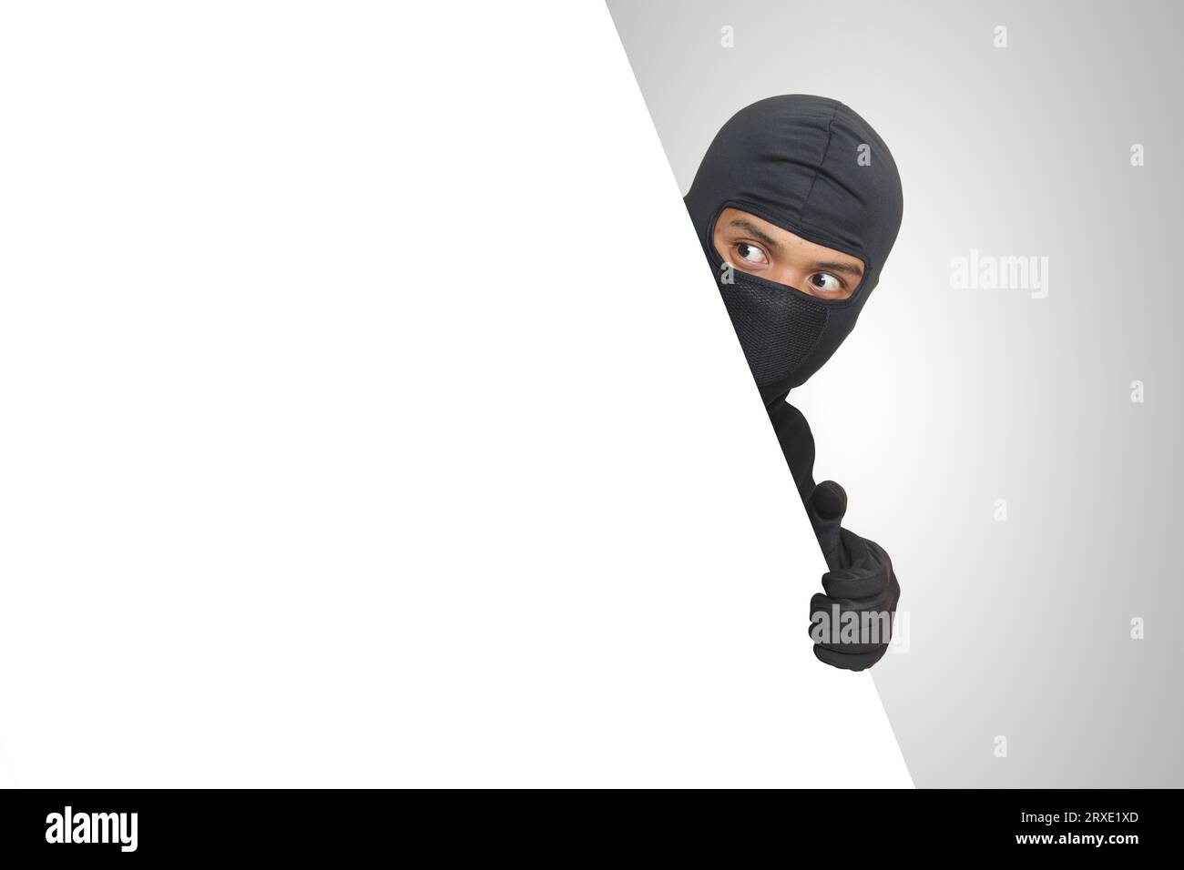 Mysterious thief wearing black hoodie hiding behind wall, sneaking, and ...