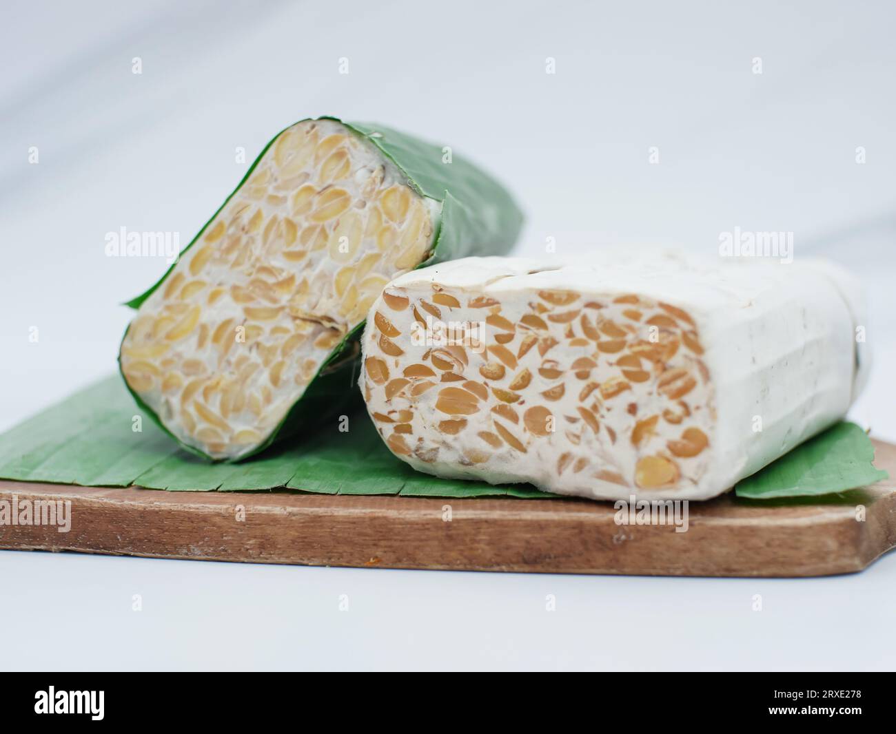 raw tempeh or tempe. Fresh tempeh still wrapped in banana leaves ...