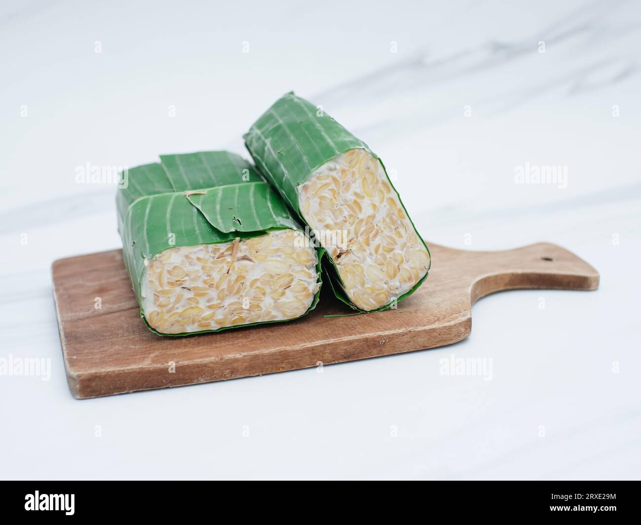 raw tempeh or tempe. Fresh tempeh still wrapped in banana leaves ...