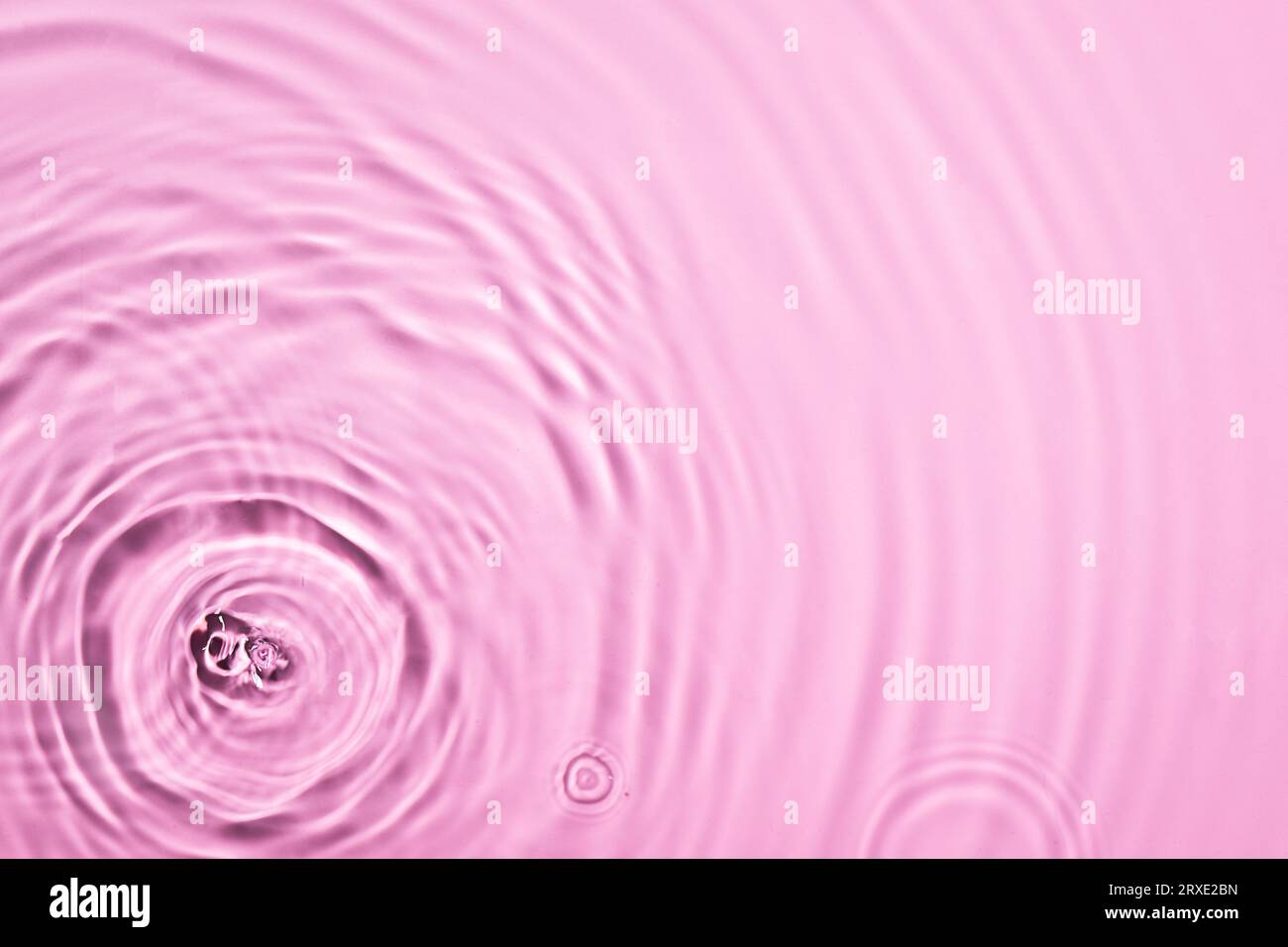 Pink water surface texture with splashes and bubbles. Abstract ...