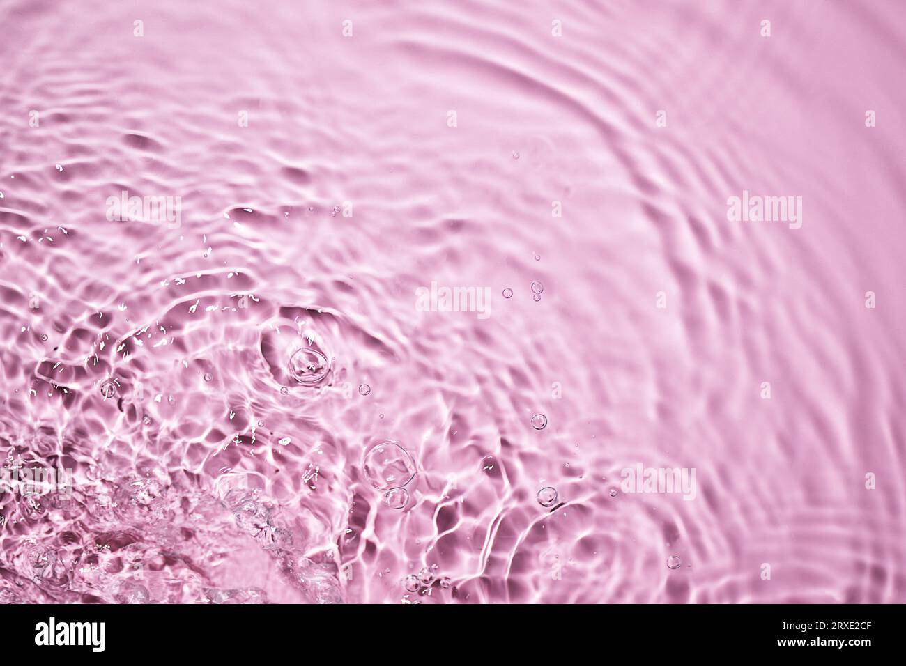 Pink water surface texture with splashes and bubbles. Abstract ...
