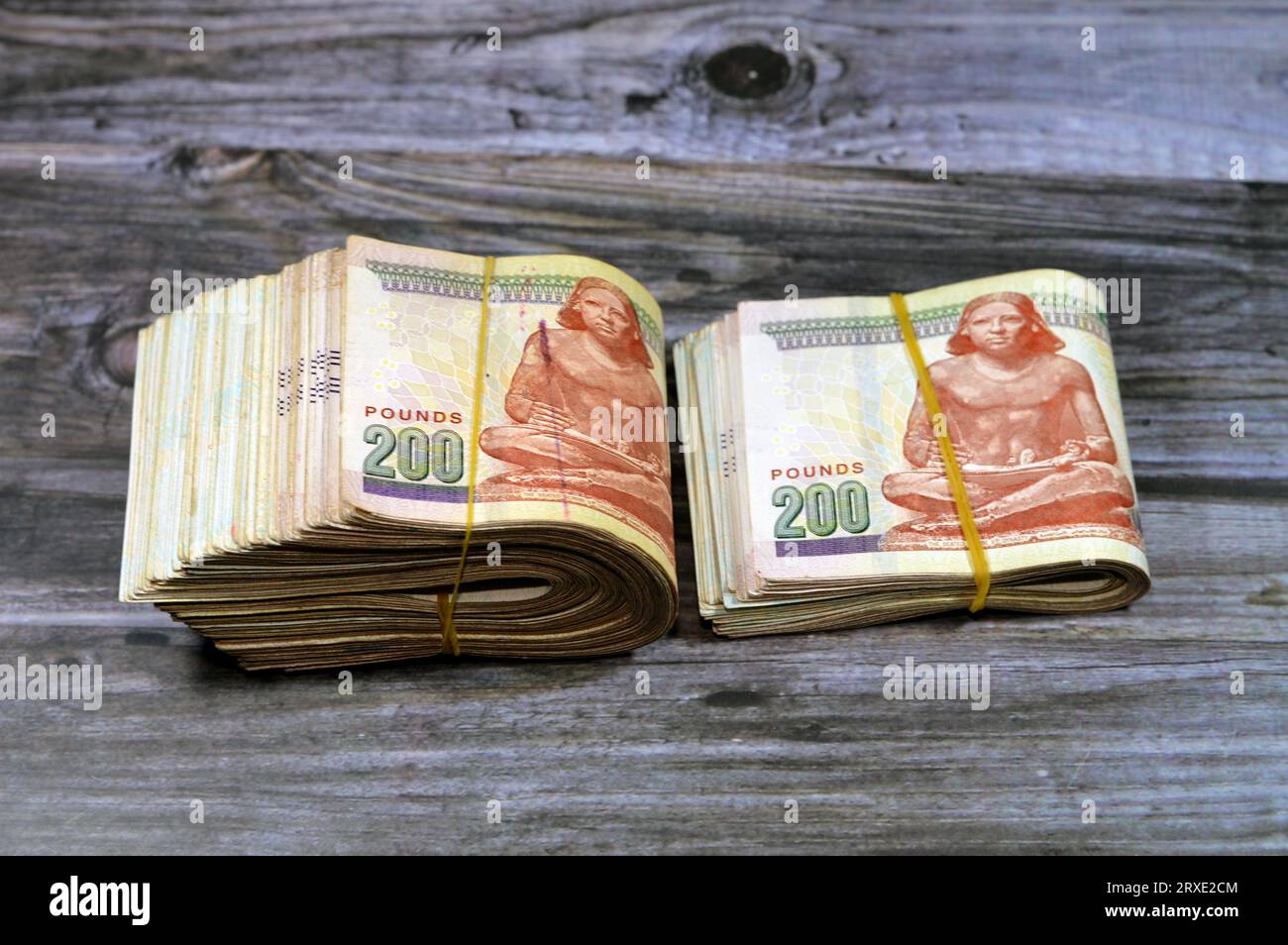 Folded Egyptian money isolated on wooden background, 200 LE two hundred ...