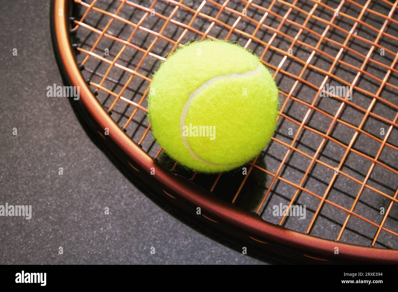 Modern brown tennis racquet with yellow ball on the strings. Isolated ...