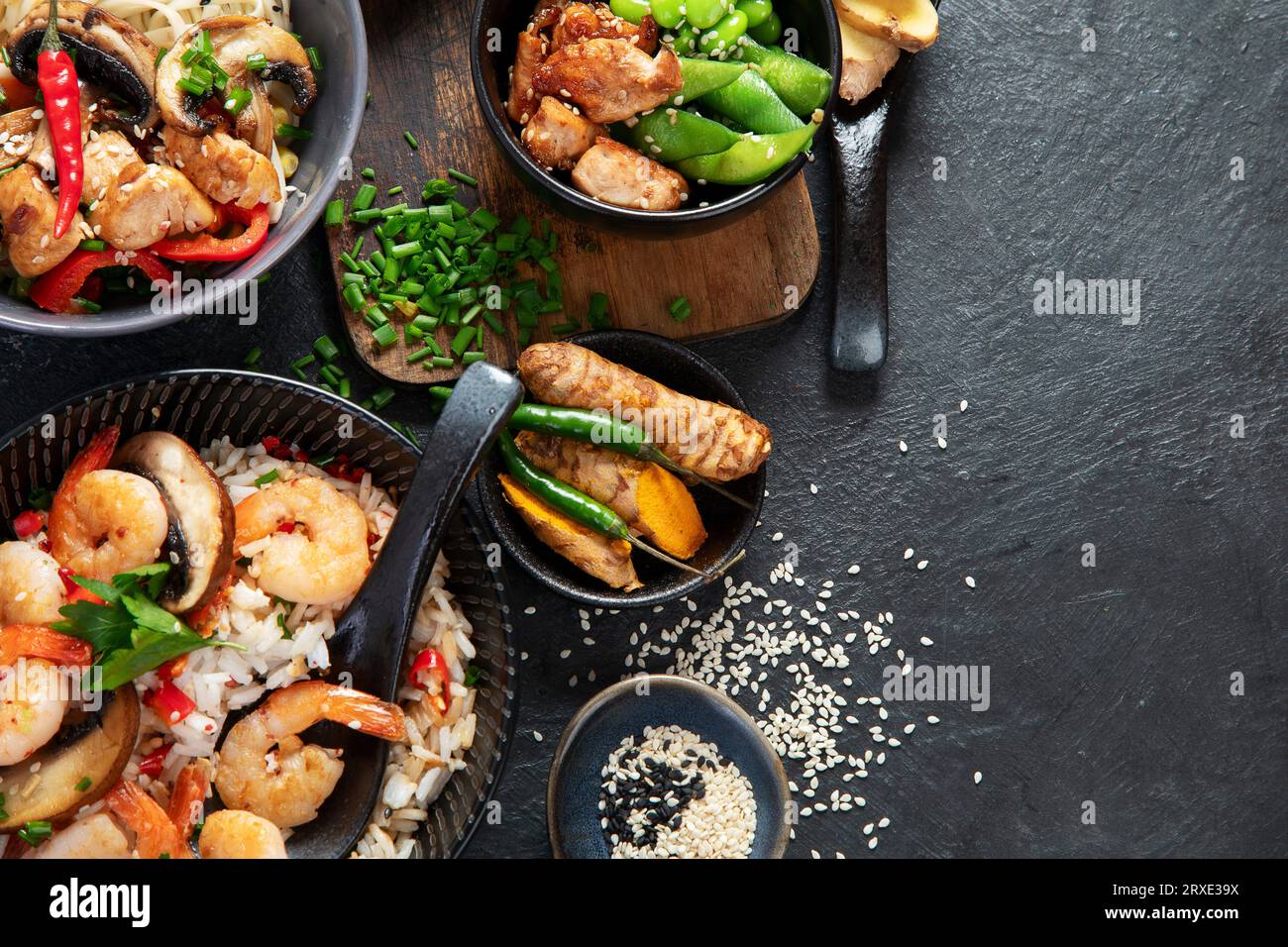 Asian food background with various ingredients on a black background ...