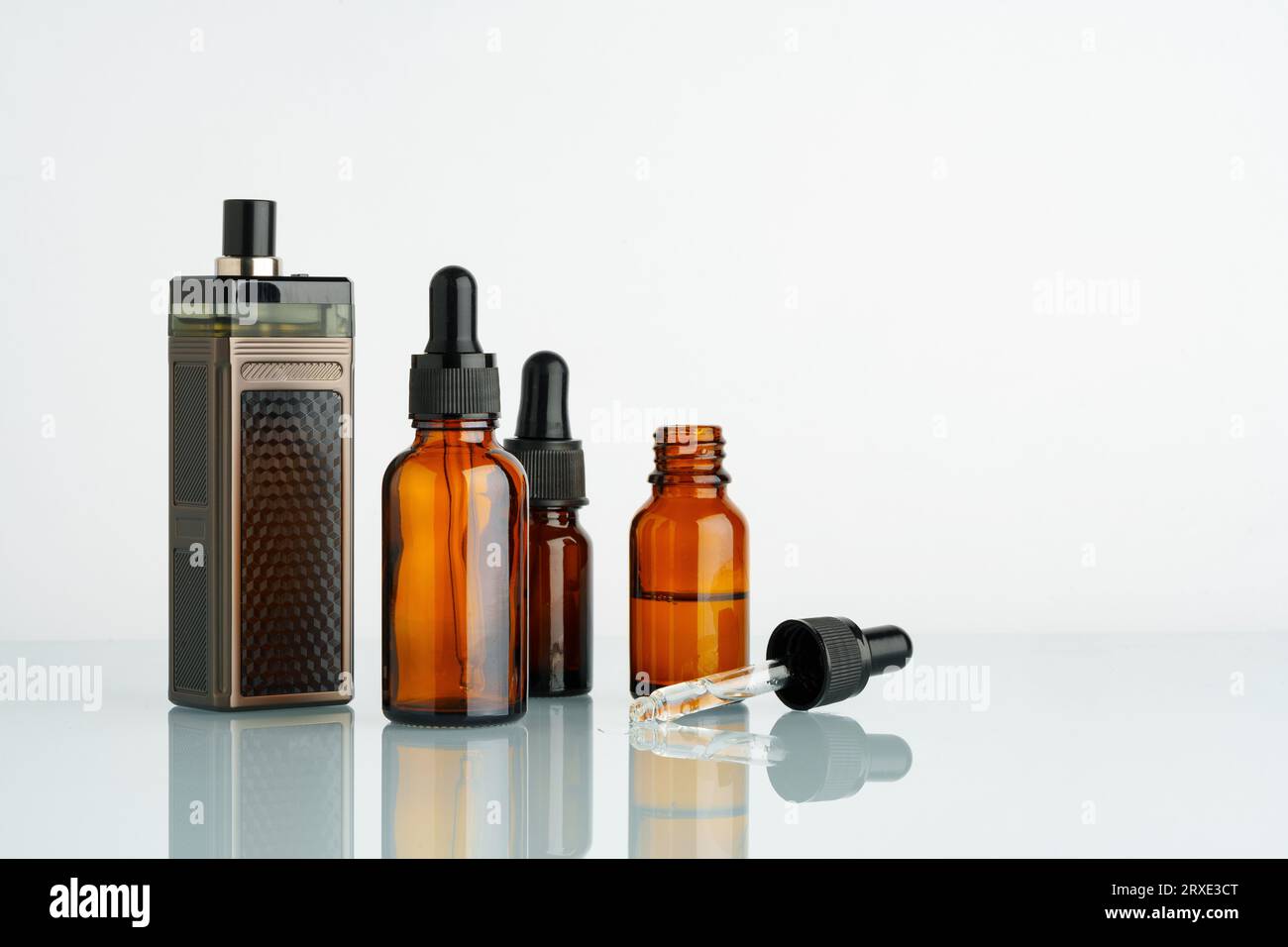 Electronic cigarette with smoking liquid bottle on white background ...