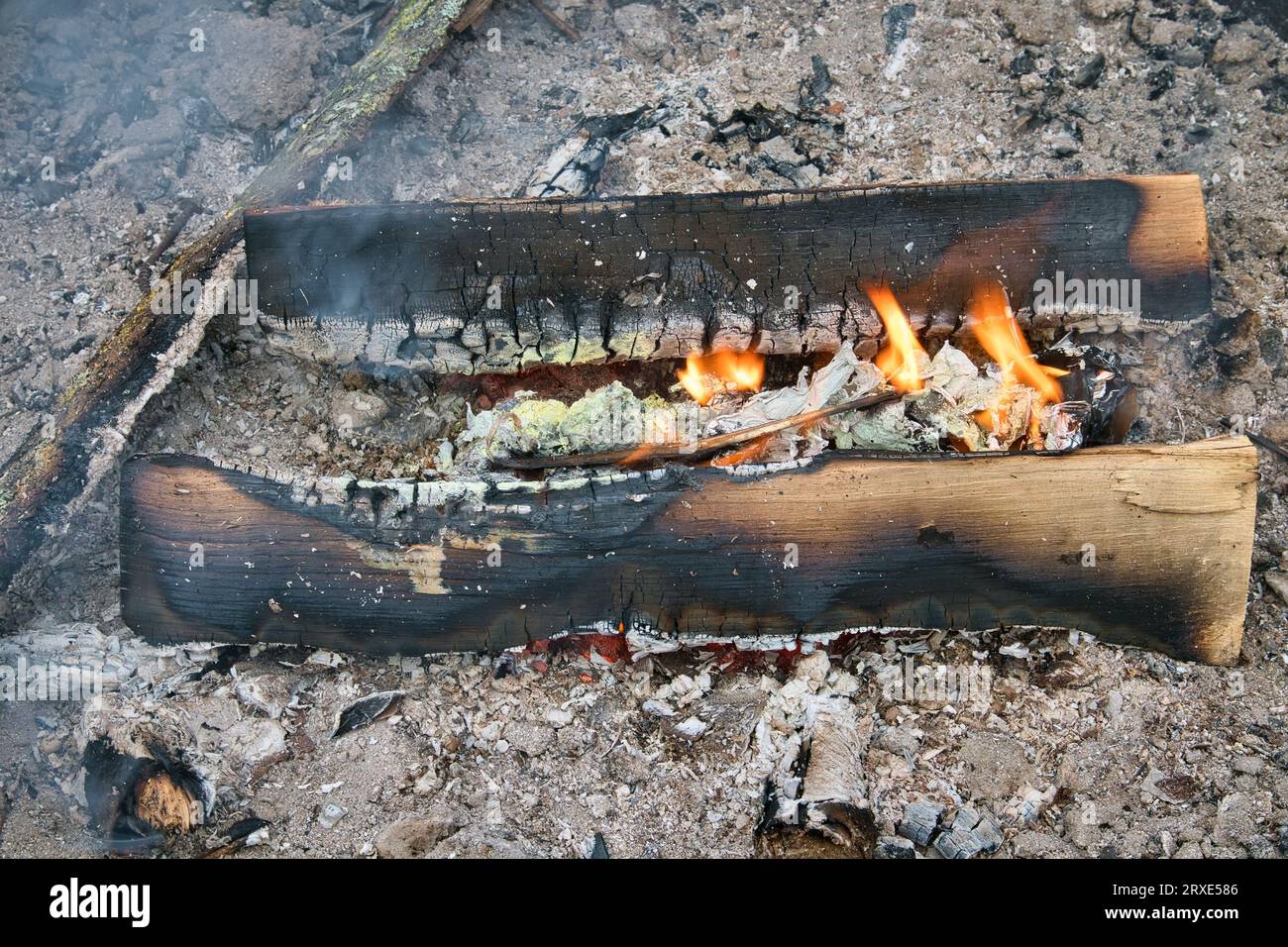 smoking logs in a camping site campfire Stock Photo - Alamy