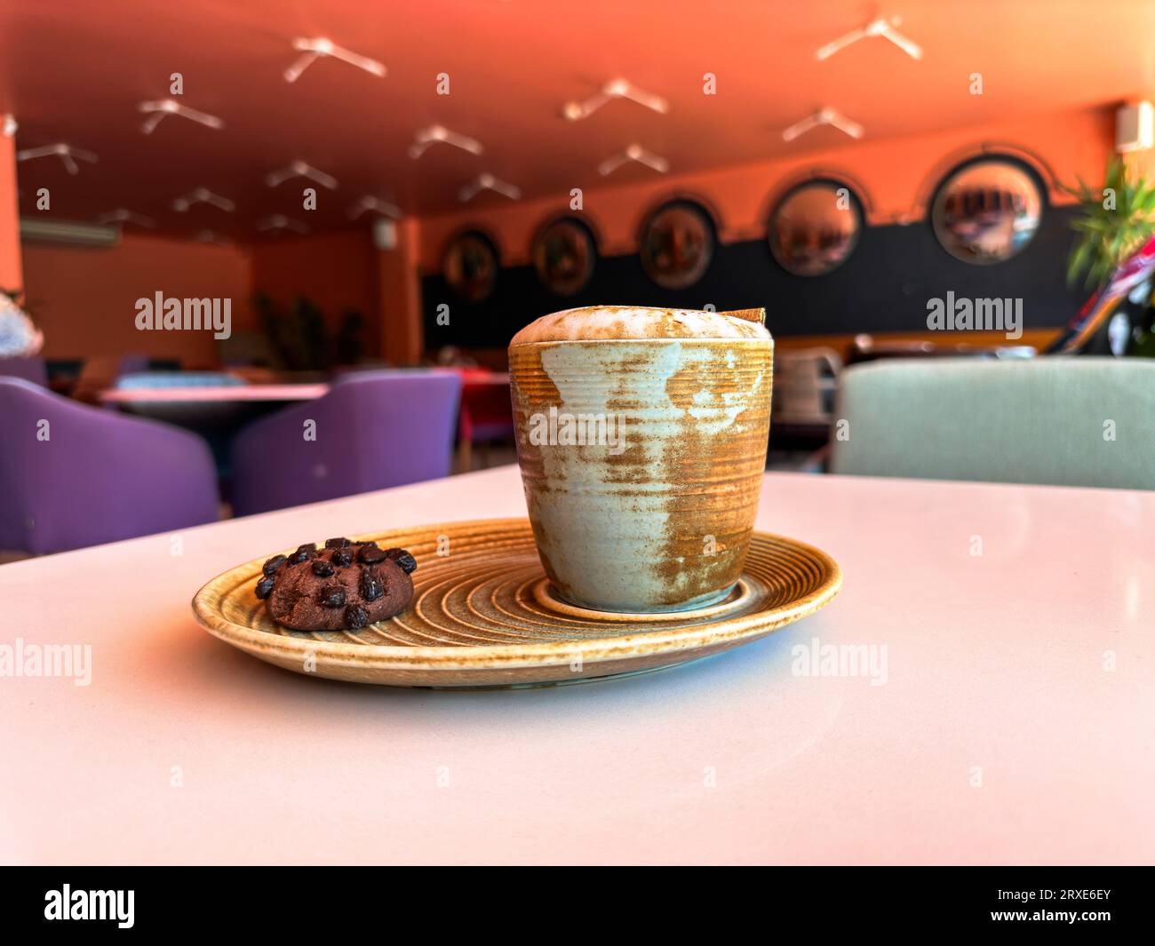 Cup of coffee and cookie in a nice modern cafe Stock Photo - Alamy